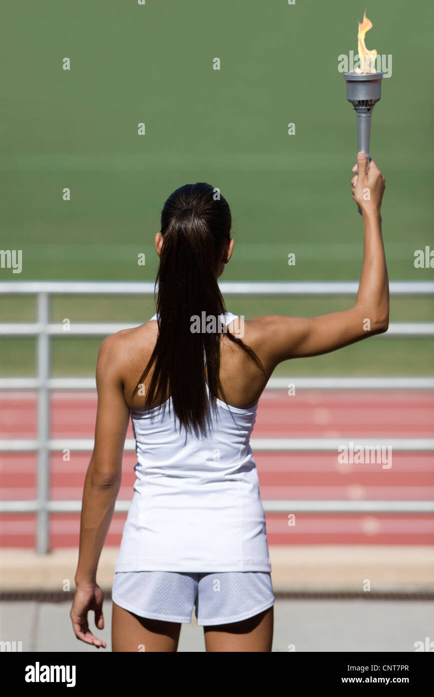 Athletes hold up torch in hi-res stock photography and images - Alamy