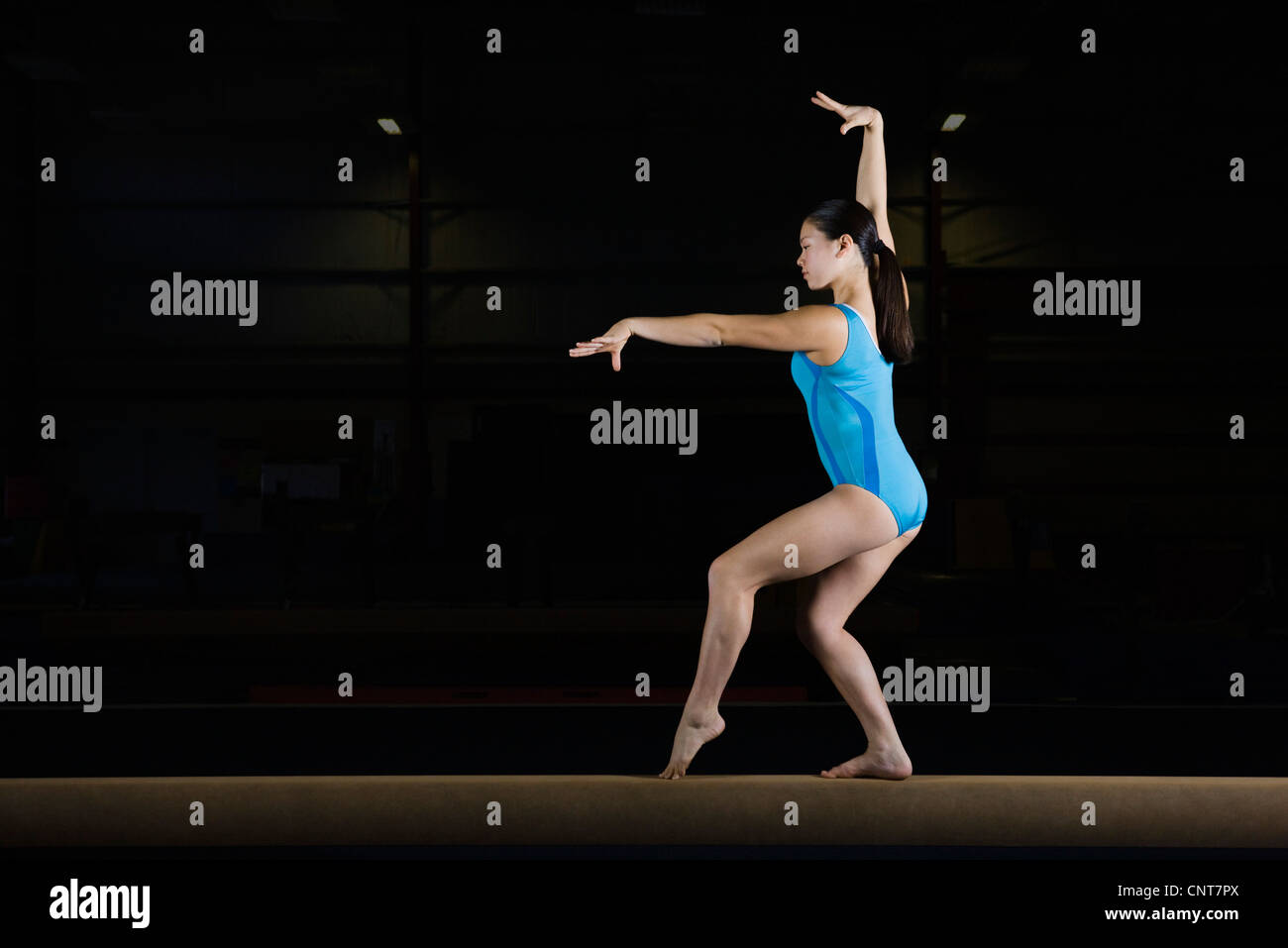 Teenage girl gymnast performing on balance beam Stock Photo - Alamy