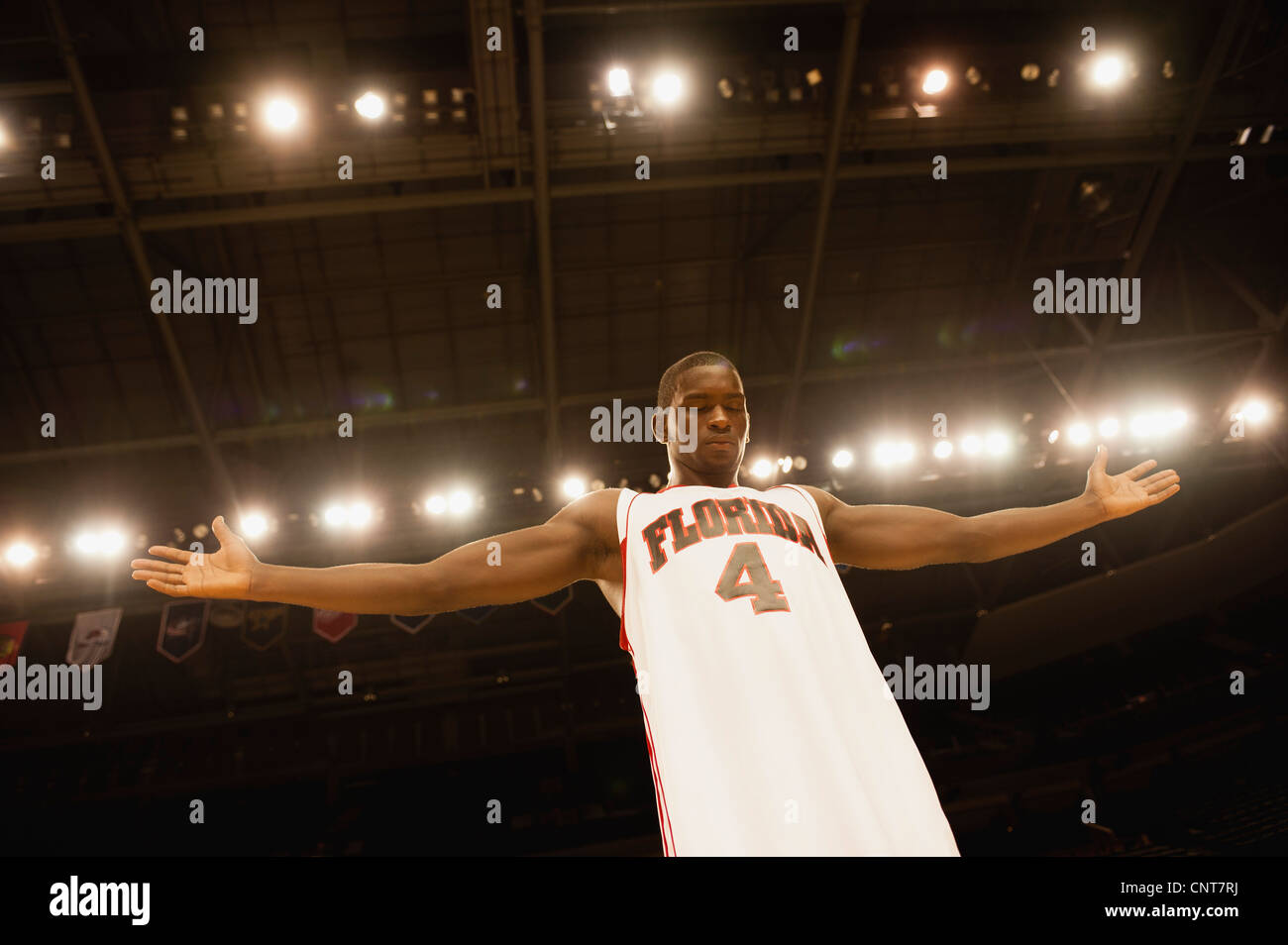 Basketball player standing with arms out, low angle view Stock Photo ...