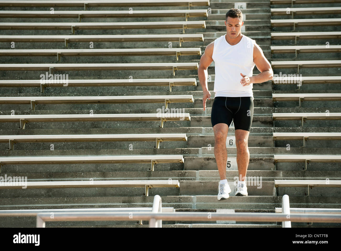 Man running down stadium steps Stock Photo - Alamy