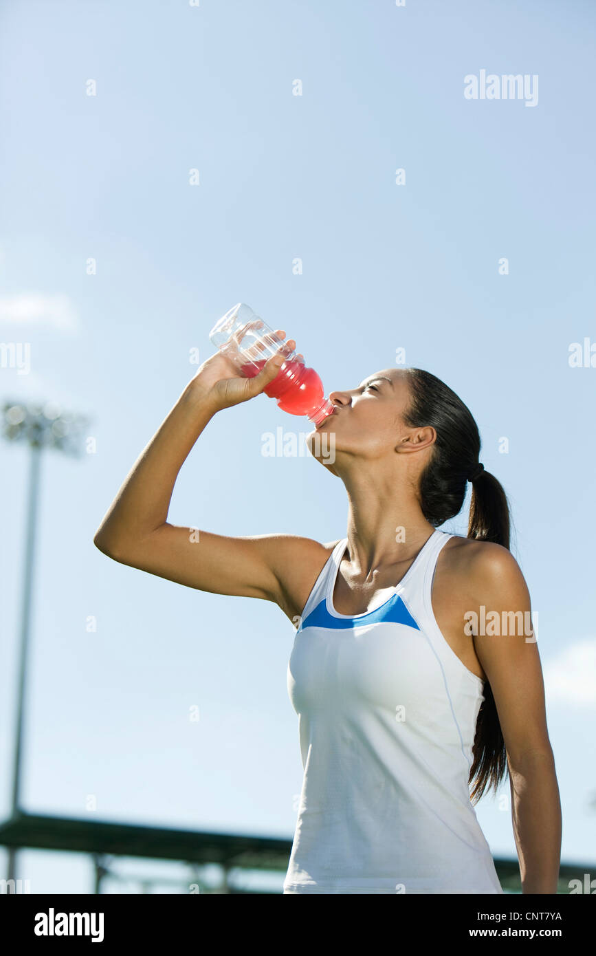 Young female athlete drinking sports drink, portrait Stock Photo - Alamy
