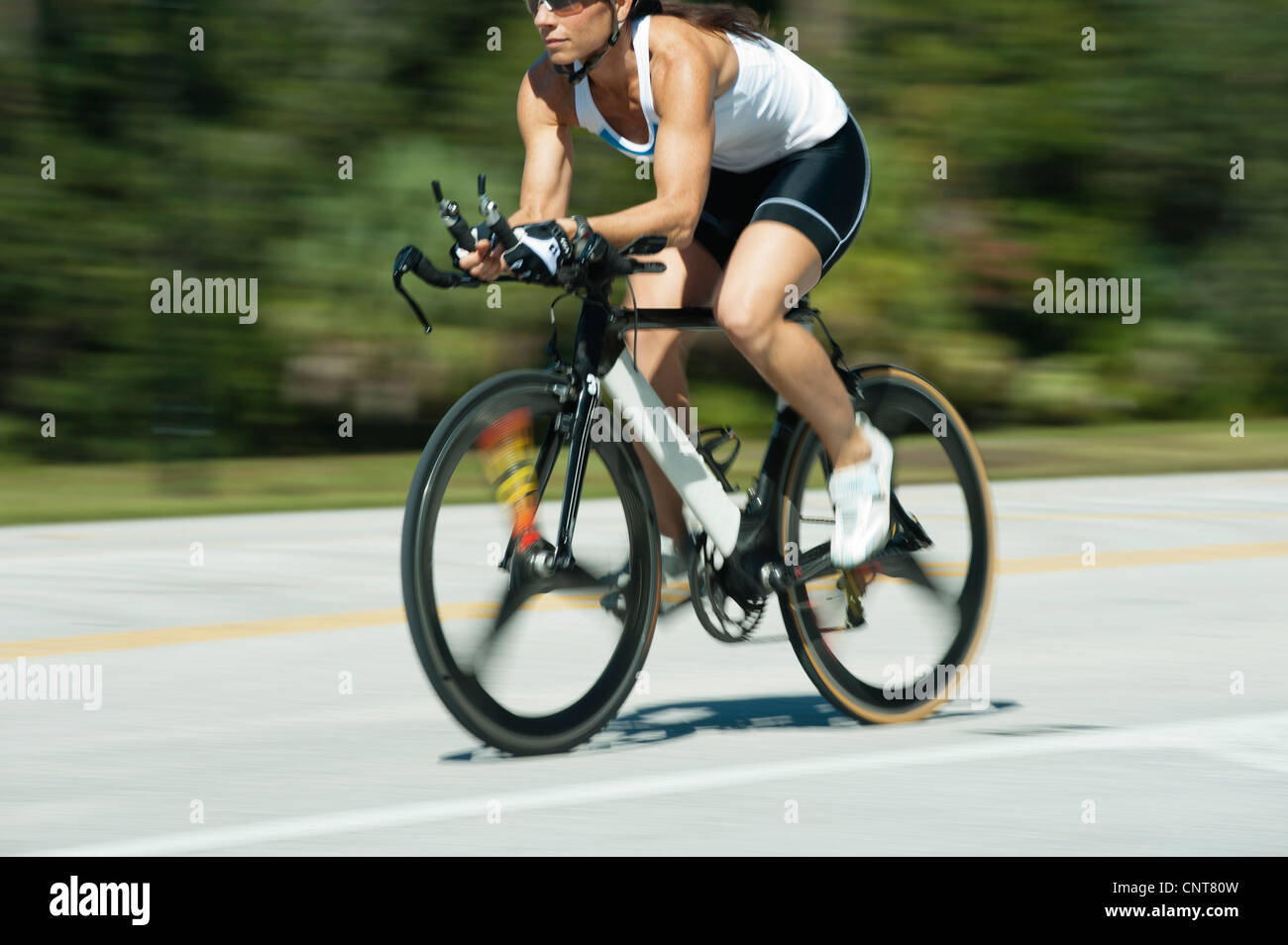 Woman riding road bike, cropped Stock Photo - Alamy