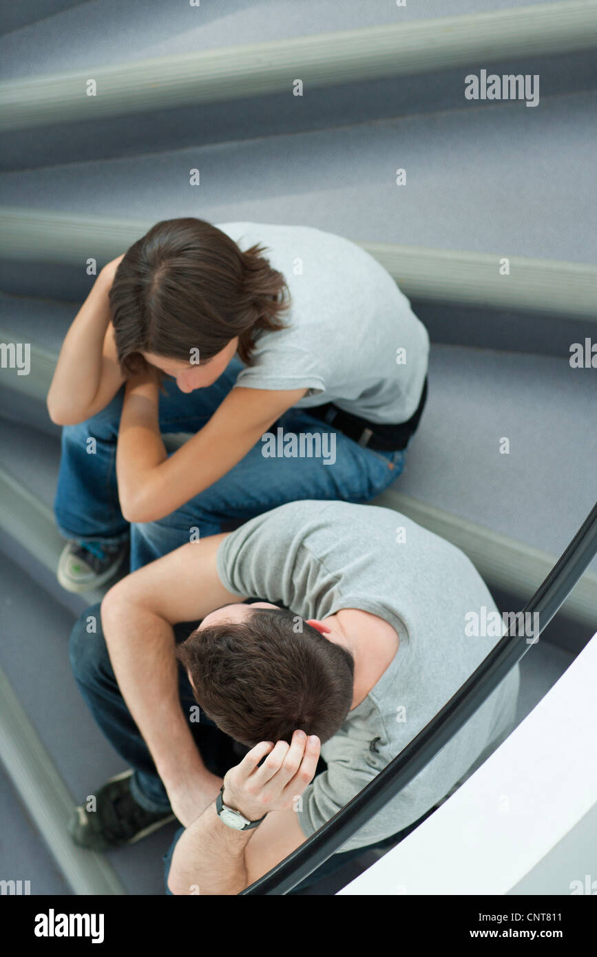Two men sitting on stairs talking hi-res stock photography and images ...