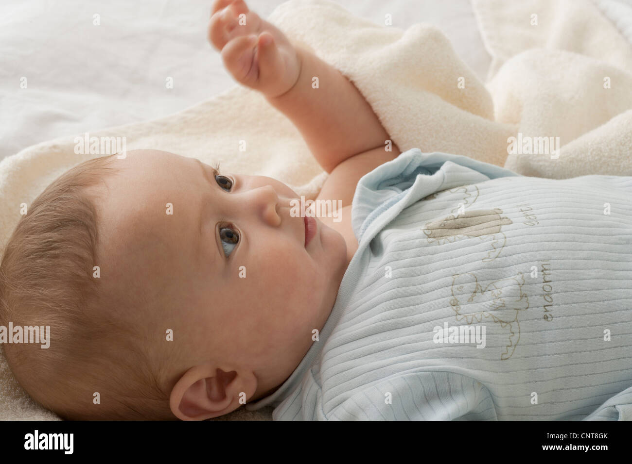 Baby boy lying on back, looking up Stock Photo - Alamy