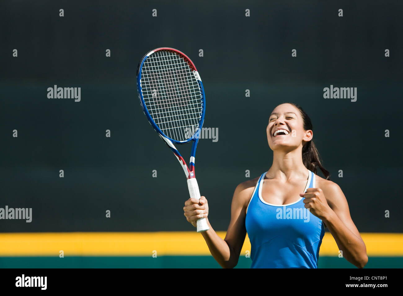 Young female tennis player cheering, portrait Stock Photo - Alamy