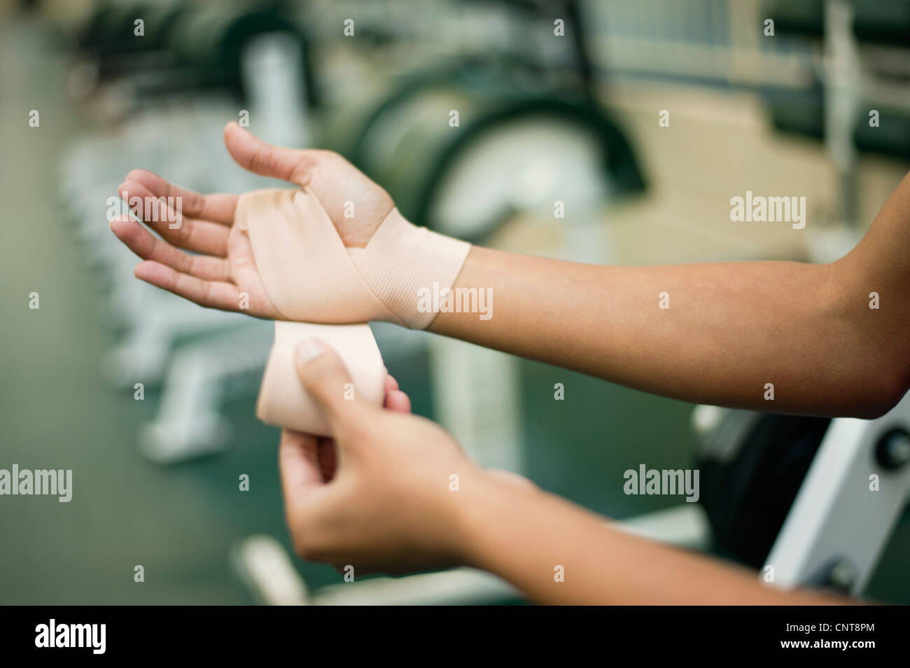 Woman wrapping hand with bandage, cropped Stock Photo - Alamy