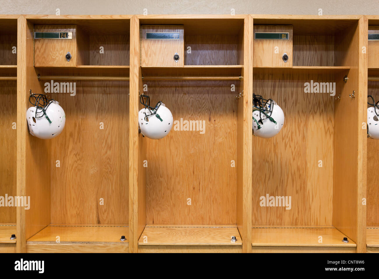 Football helmets hanging in locker room Stock Photo - Alamy