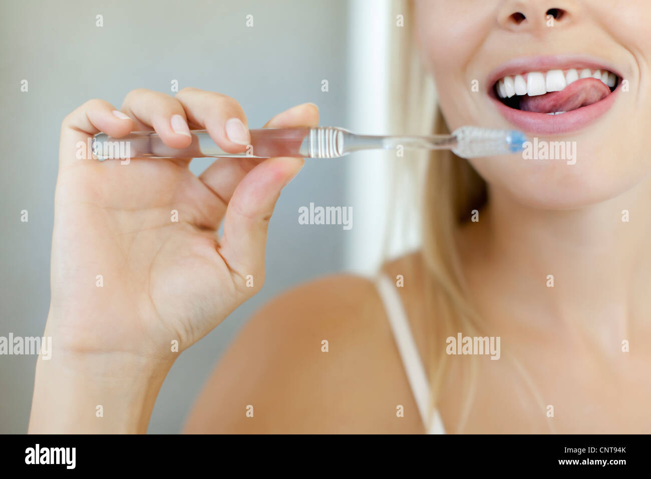 Woman brushing teeth, cropped Stock Photo - Alamy