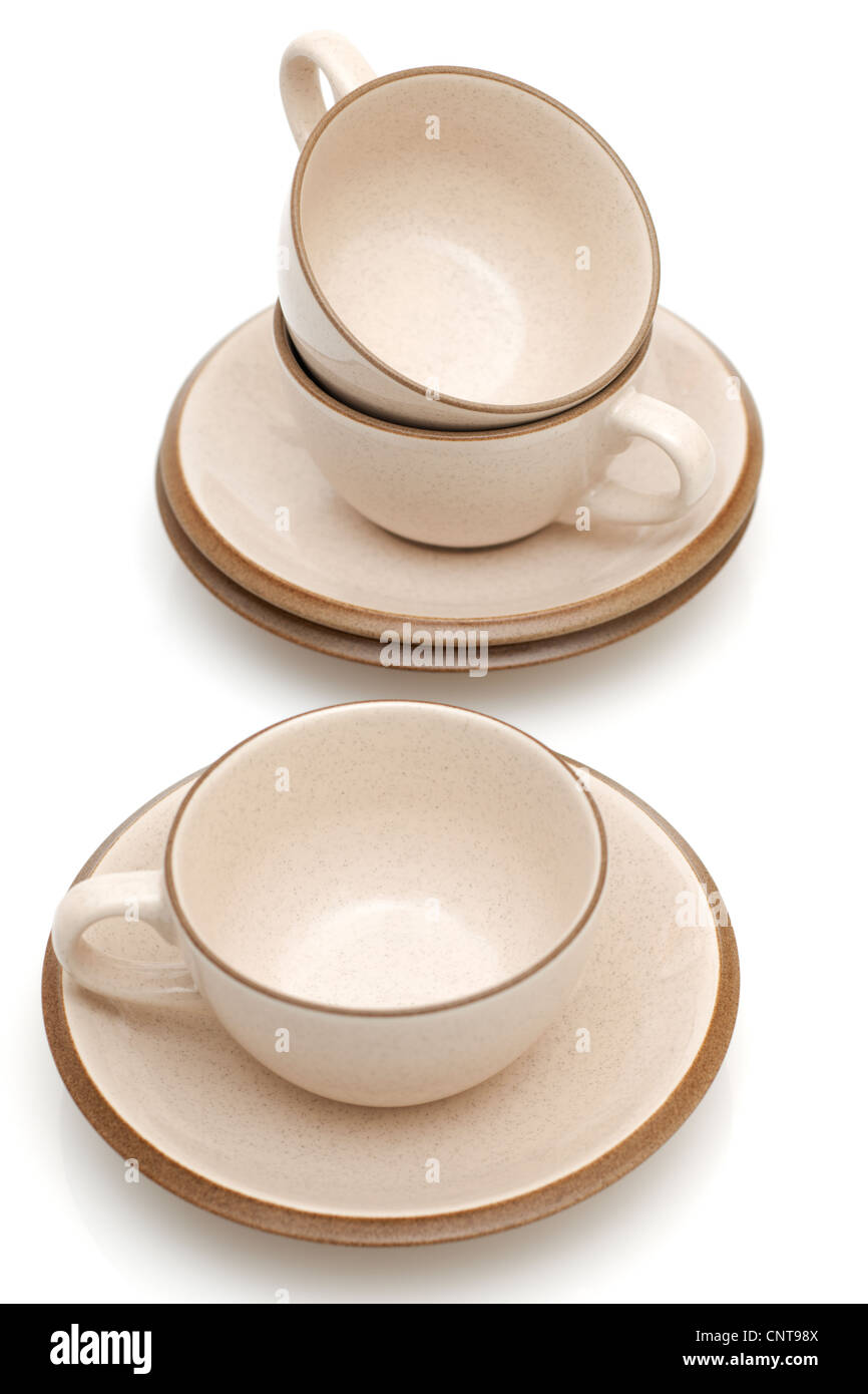 Three beige coffee cups and saucers Stock Photo - Alamy