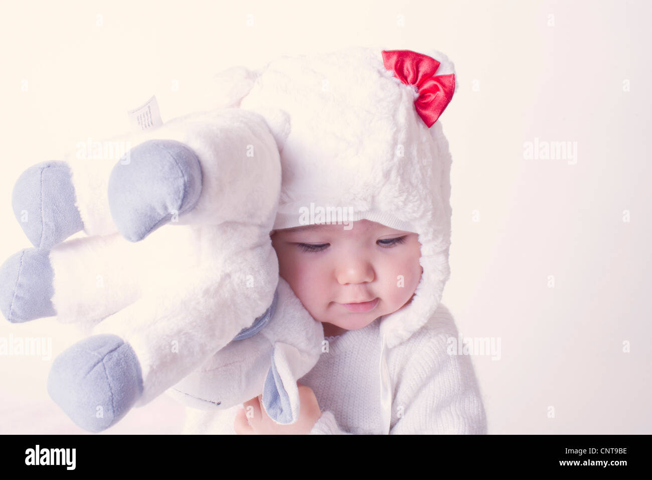 Baby girl hugging stuffed toy Stock Photo - Alamy