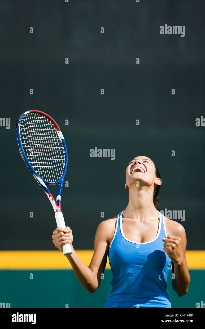 Young female tennis player cheering, portrait Stock Photo - Alamy