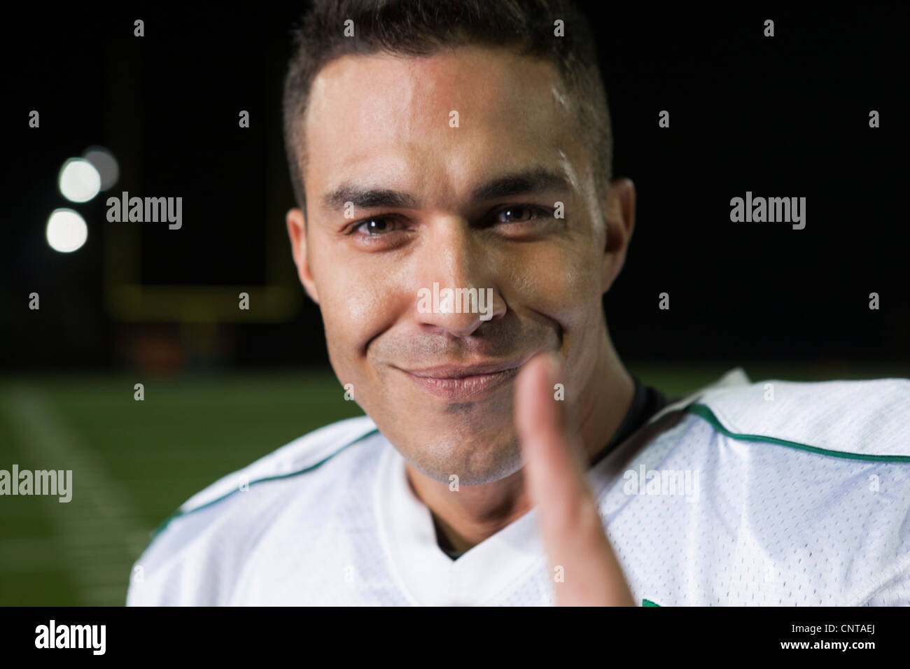 Football smiling confidently at camera, portrait Stock Photo - Alamy