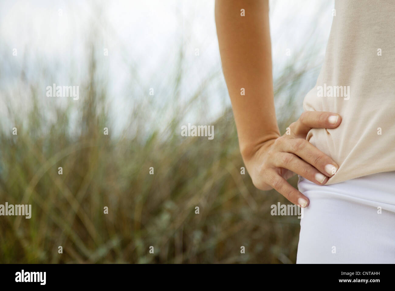 Woman with hand on hip outdoors, cropped Stock Photo - Alamy
