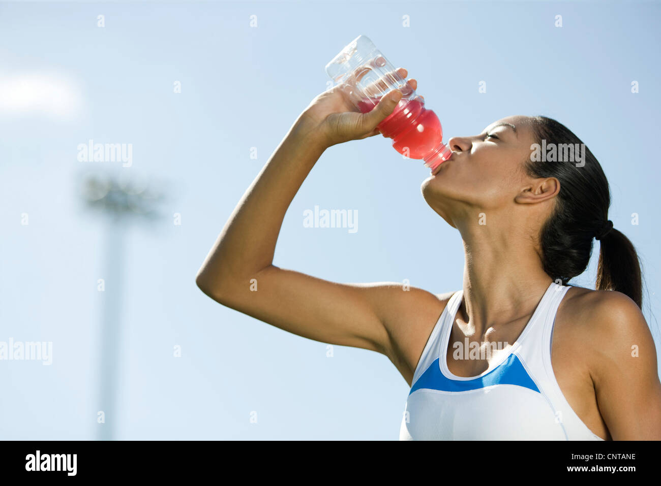 Young female athlete drinking sports drink, portrait Stock Photo - Alamy