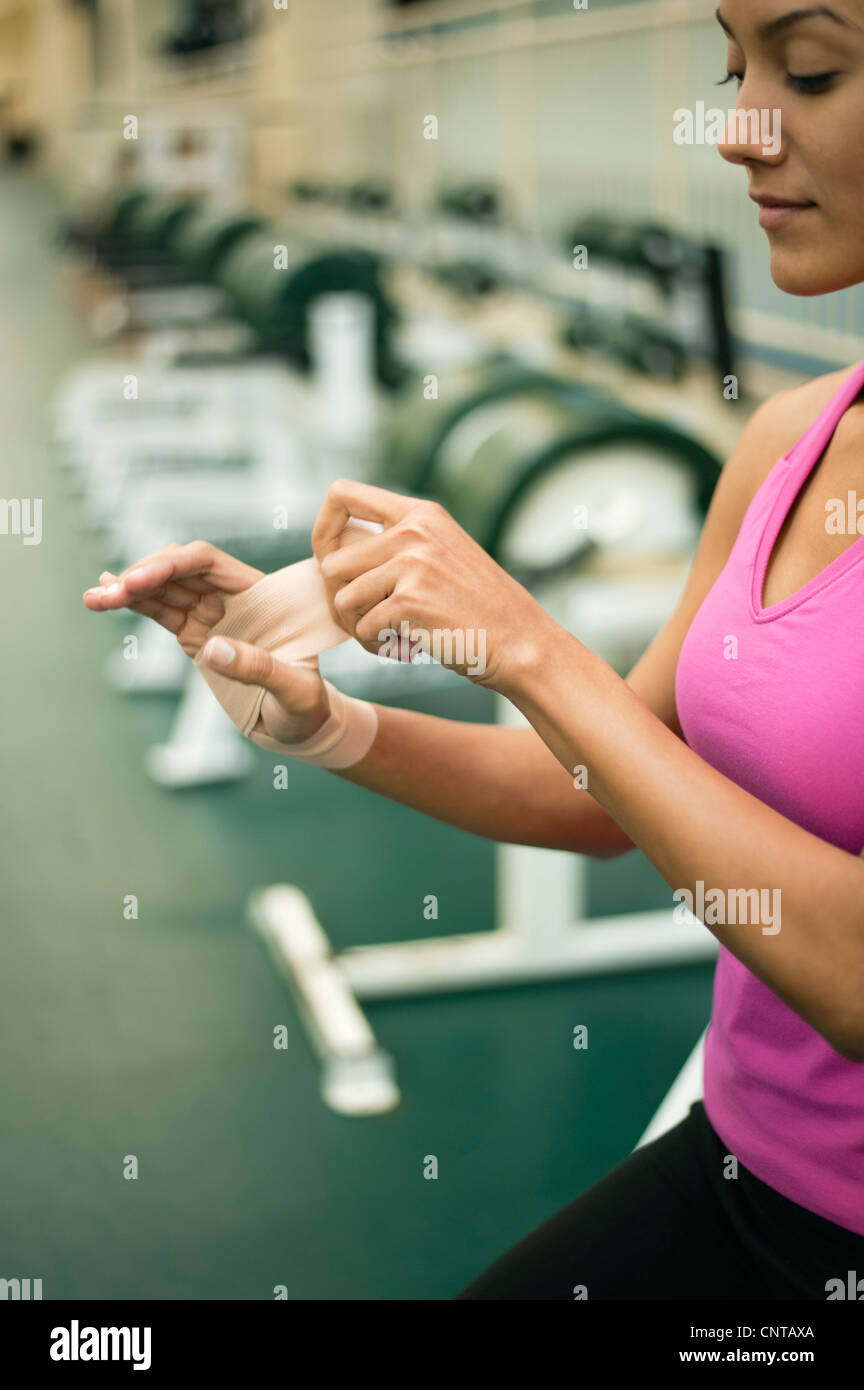 Young woman wrapping hand with bandage, cropped Stock Photo - Alamy