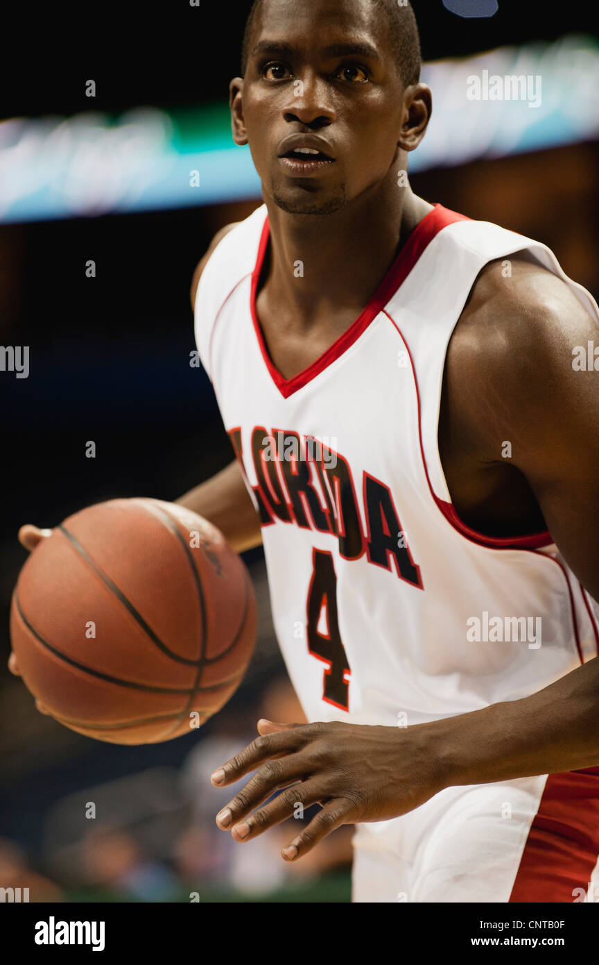 Basketball player dribbling ball Stock Photo - Alamy