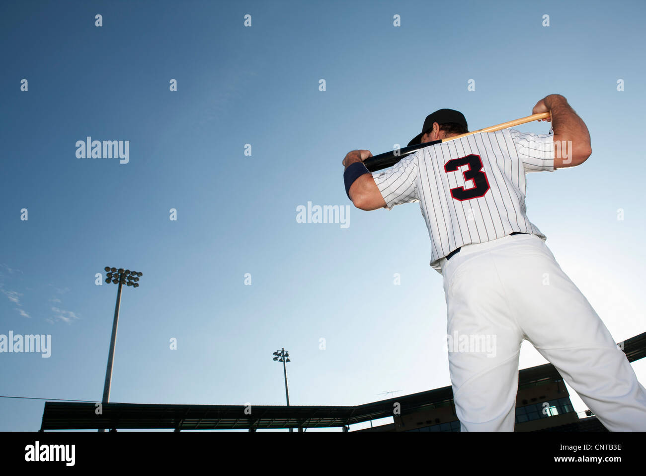 Baseball player holding bat, rear view Stock Photo - Alamy