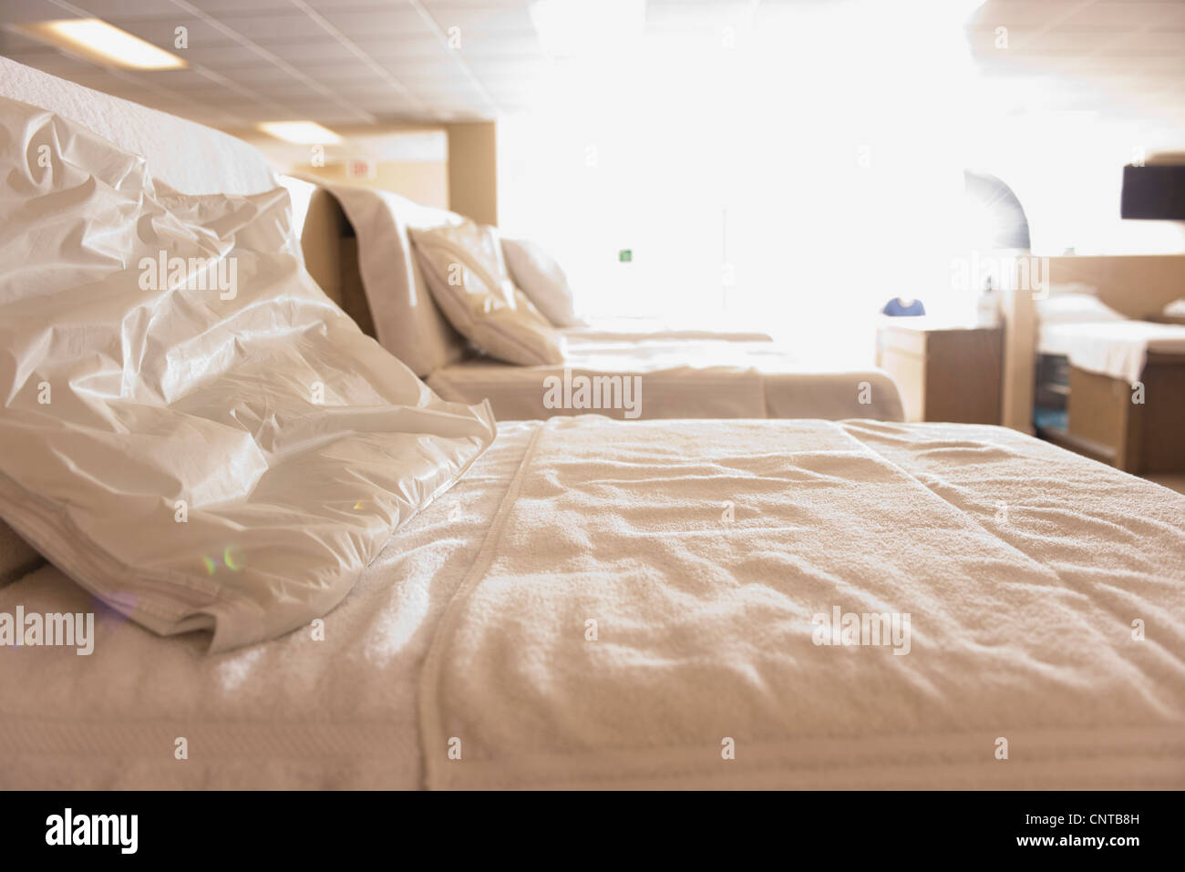 Beds in empty room Stock Photo - Alamy