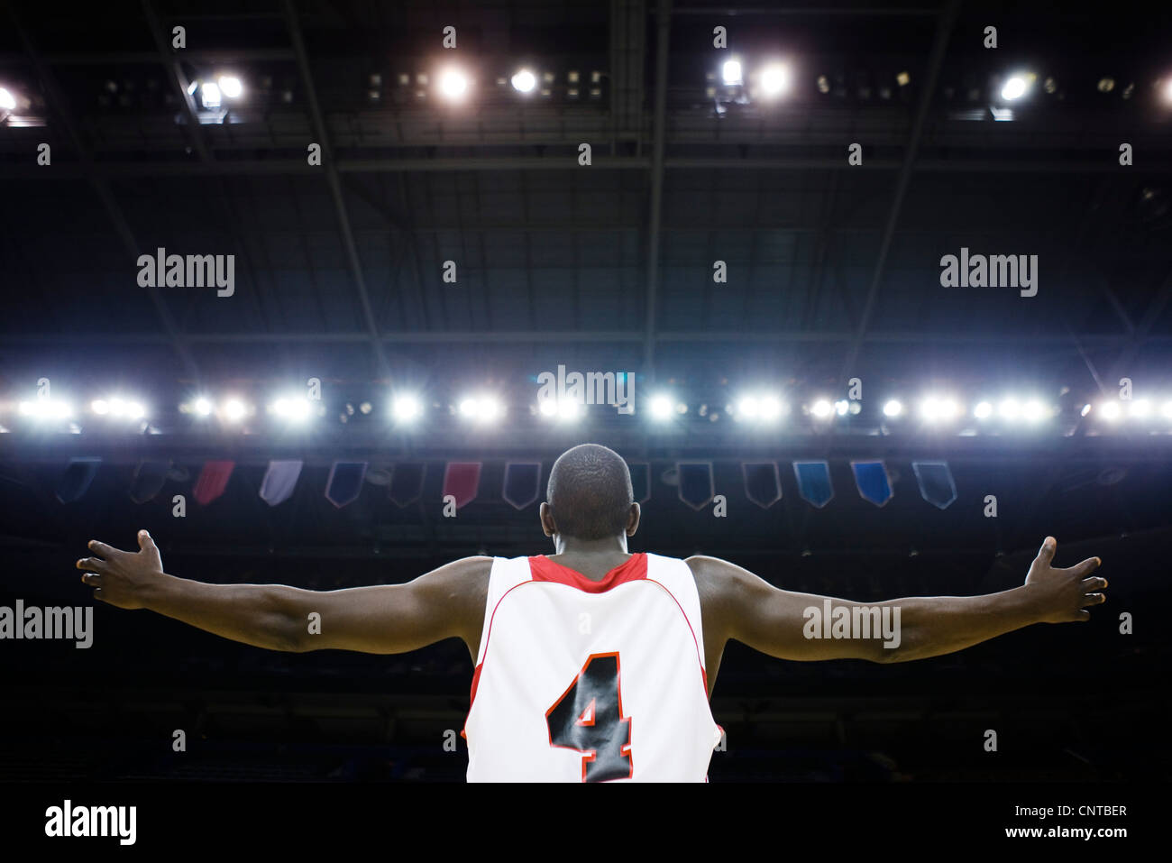 Basketball player with arms outstretched, rear view Stock Photo - Alamy