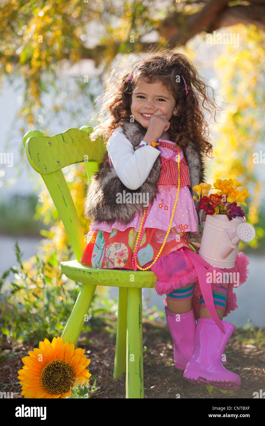 happy cute child sitting in chair outdoors in summer nature Stock Photo ...