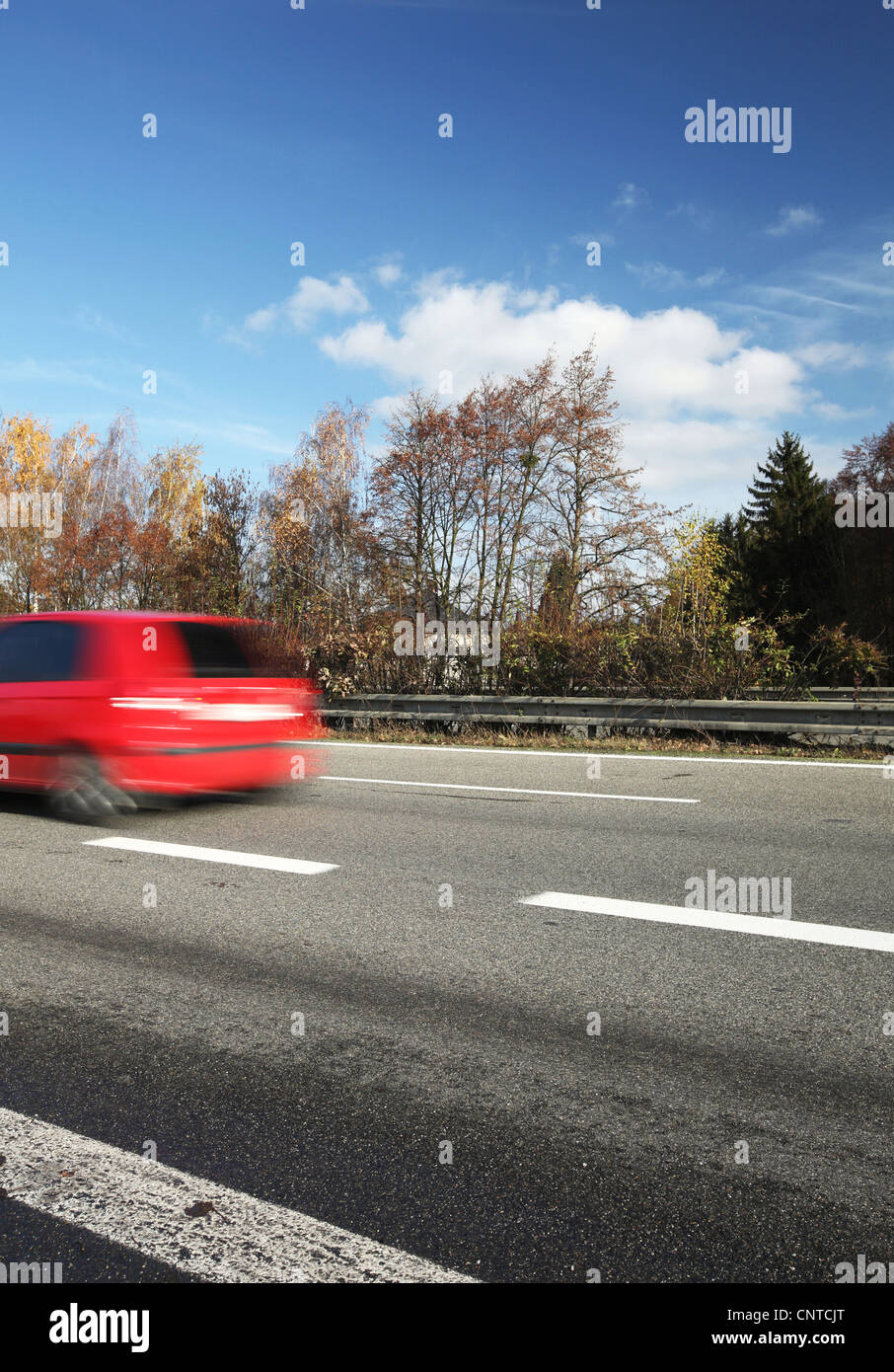 Speeding concept - Cars moving fast on a highway on a lovely autumn ...