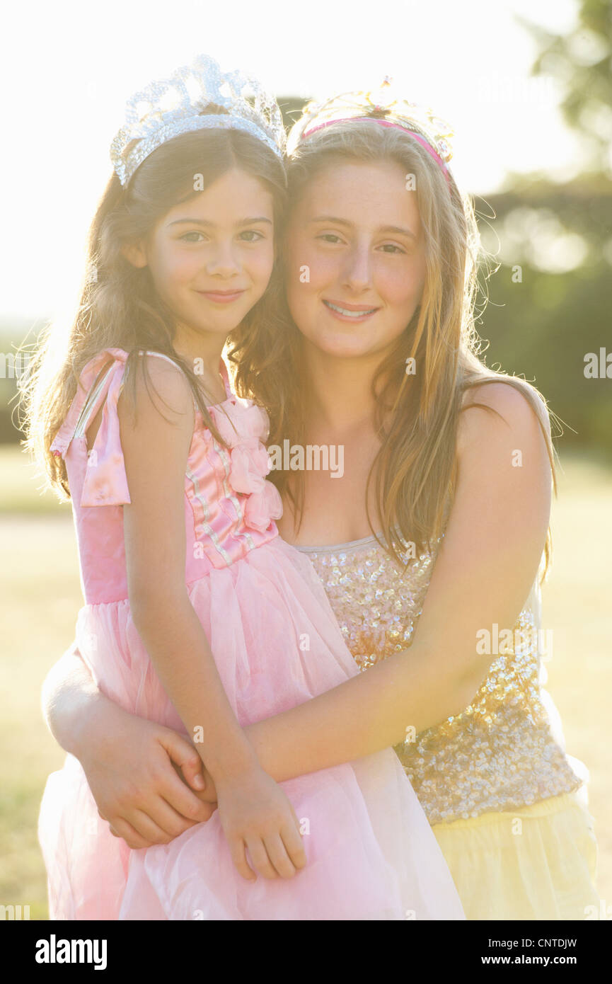 Sisters smiling together outdoors Stock Photo - Alamy