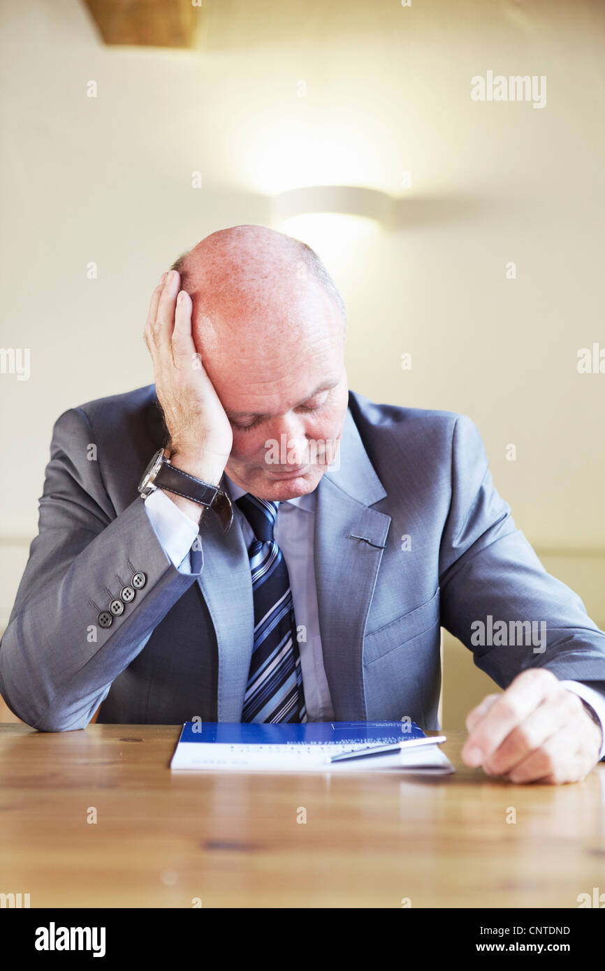 Frustrated businessman sitting in cafe Stock Photo - Alamy