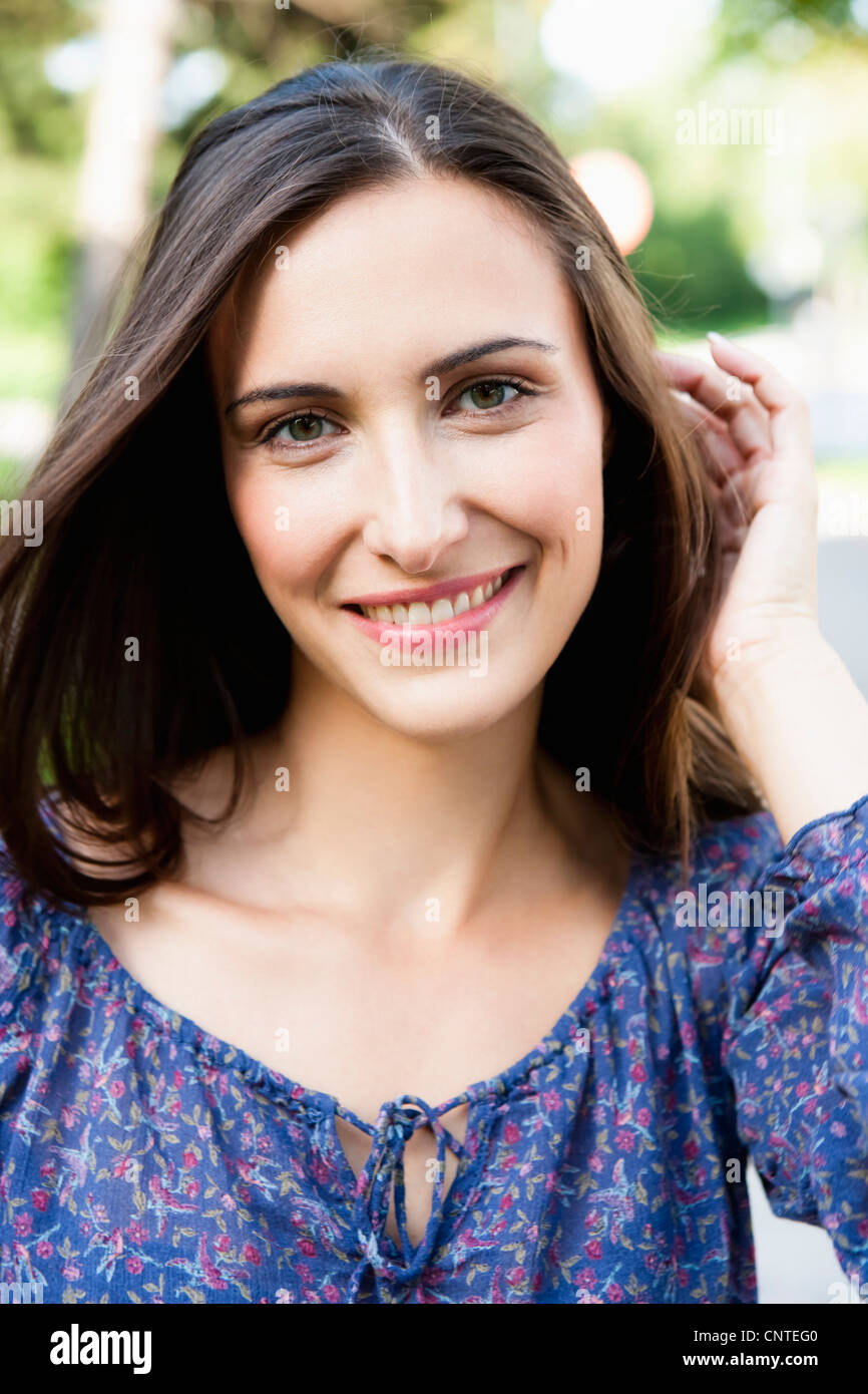 Smiling woman standing outdoors Stock Photo - Alamy