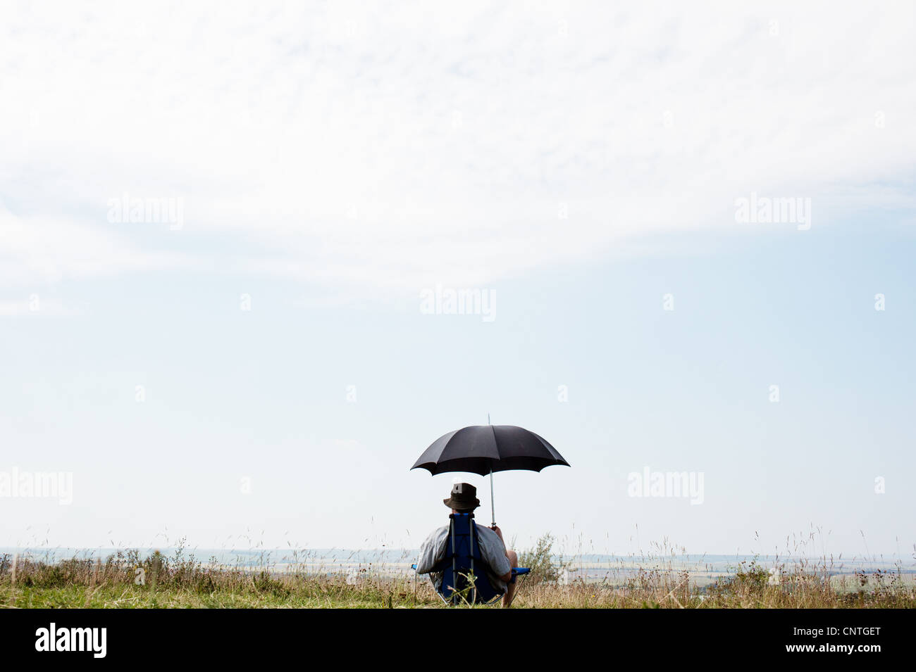Seated underneath an umbrella hi-res stock photography and images - Alamy