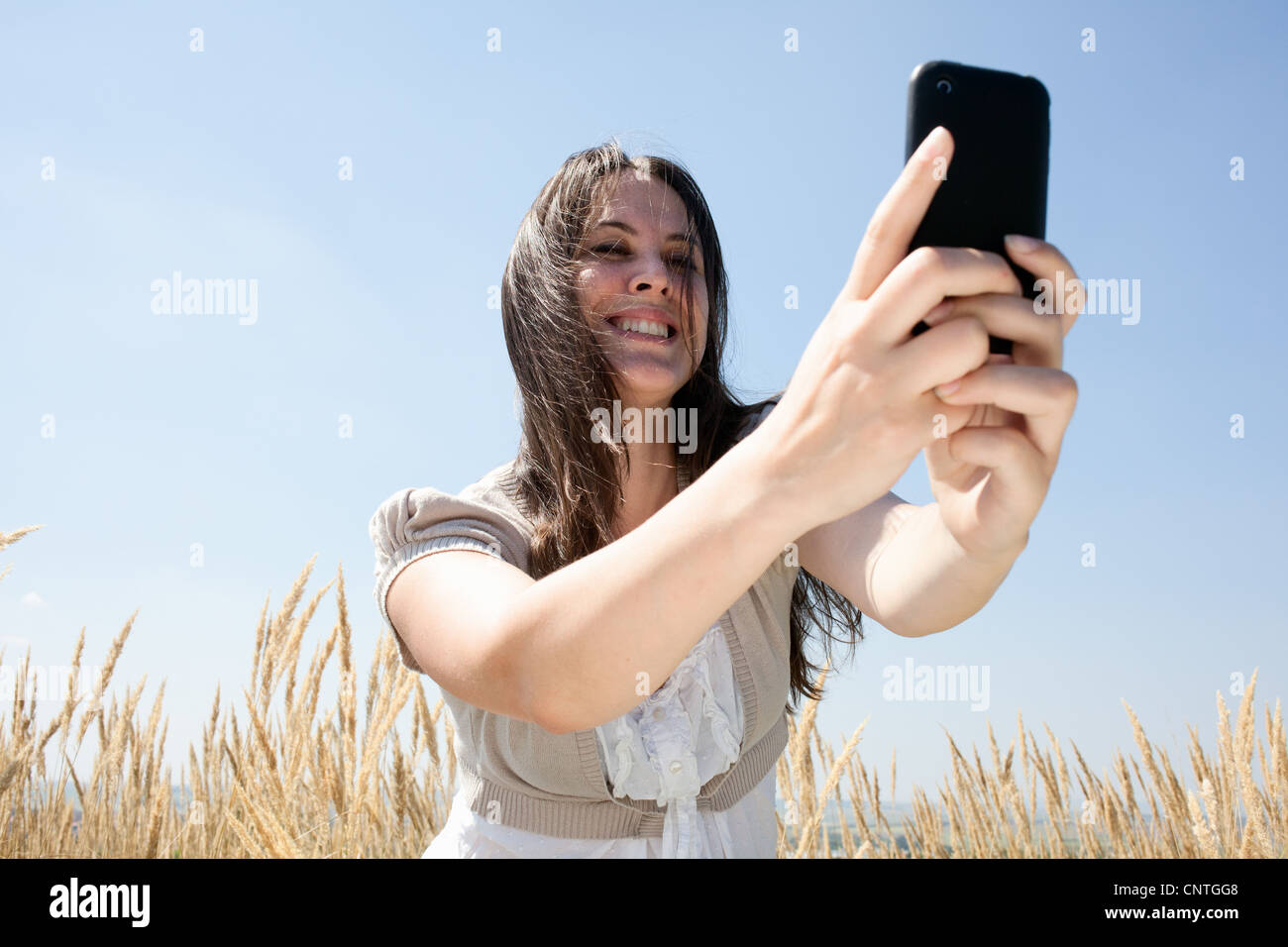 Woman taking pictures with cell phone Stock Photo - Alamy
