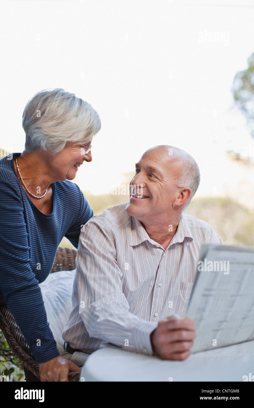 Older couple reading newspaper outdoors Stock Photo - Alamy