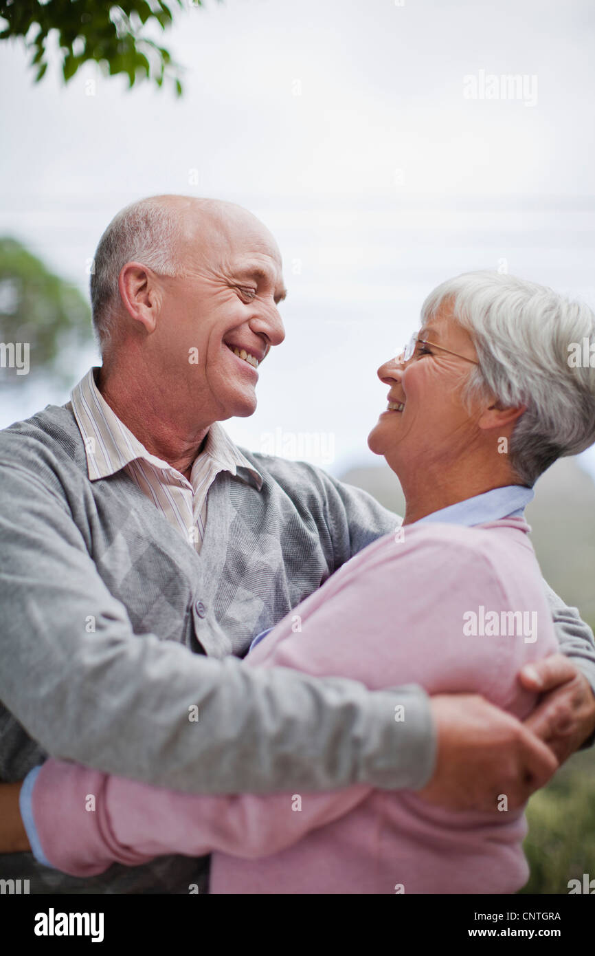 Smiling older couple hugging outdoors Stock Photo - Alamy Smiling older couple hugging outdoors Stock Photo - Alamy