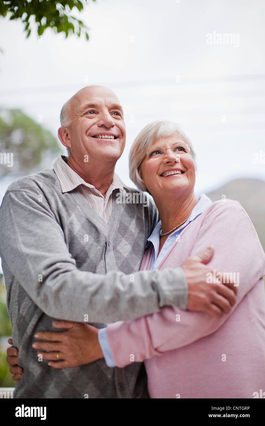 Smiling older couple hugging outdoors Stock Photo - Alamy Smiling older couple hugging outdoors Stock Photo - Alamy