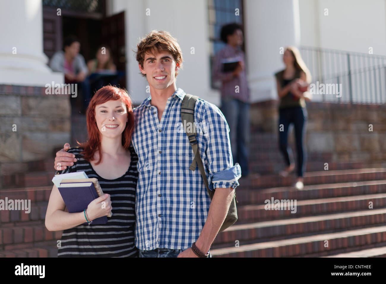 Students hugging on campus Stock Photo - Alamy