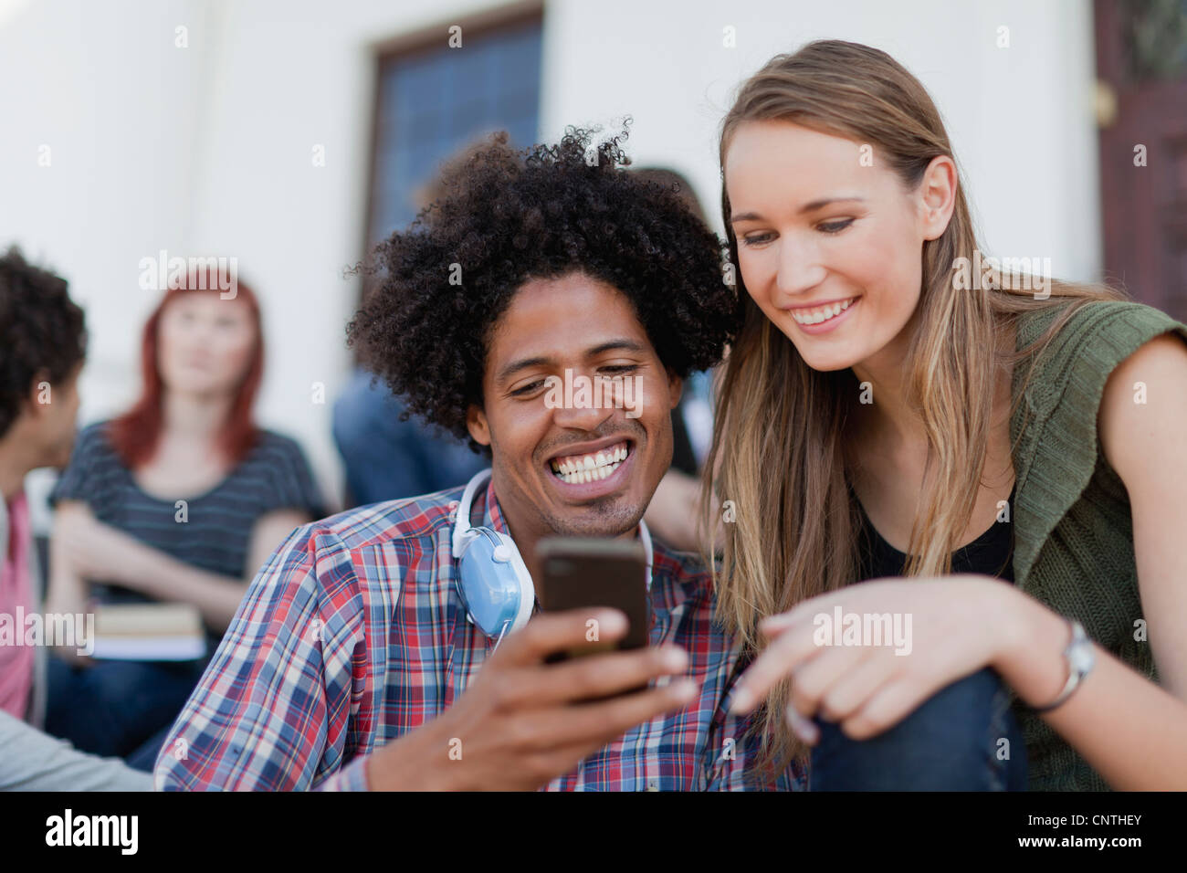 Students using cell phone on campus Stock Photo - Alamy