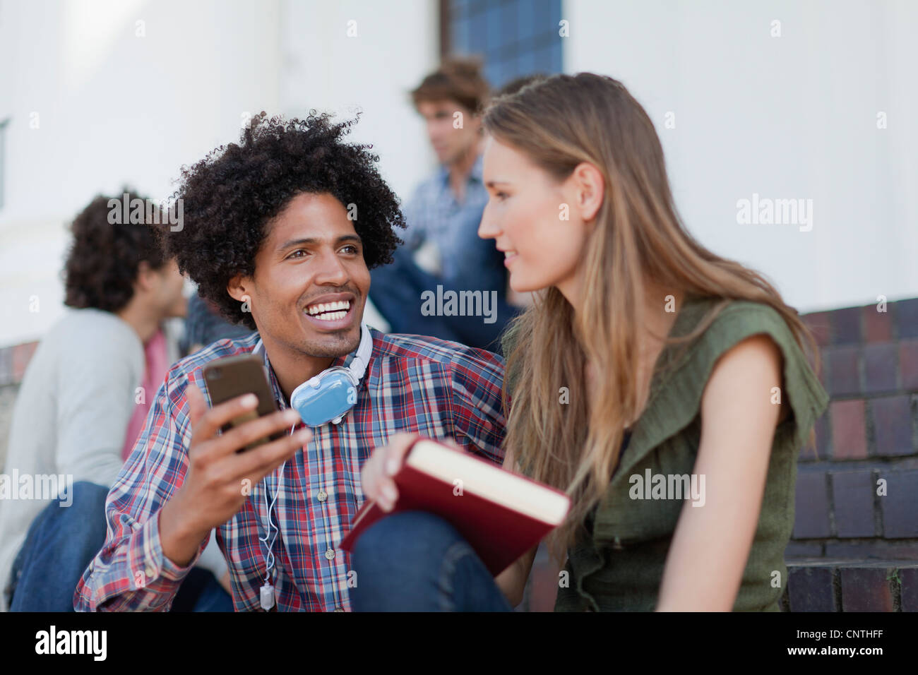 Students using cell phone on campus Stock Photo - Alamy