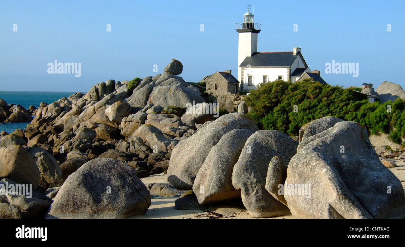 Lighthouse on the coast between rocks in Finistere in Brittany in ...