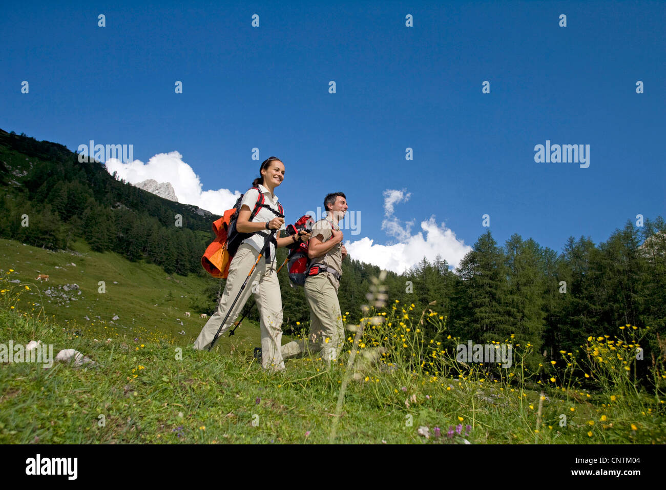 couple wandering in a mountain scenery. Man and woman walking through a ...