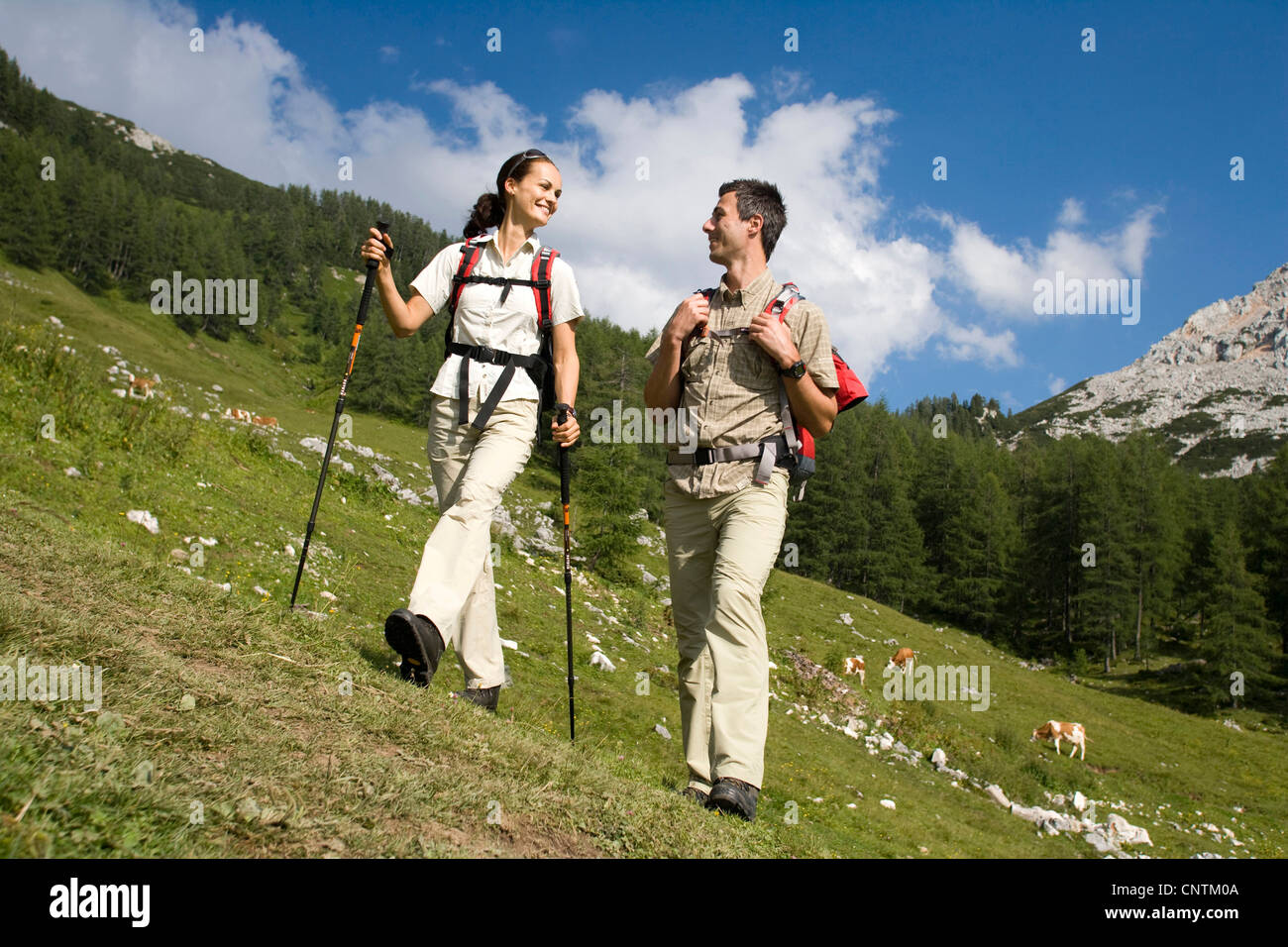 couple wandering in a mountain scenery. Man and woman walking through a ...
