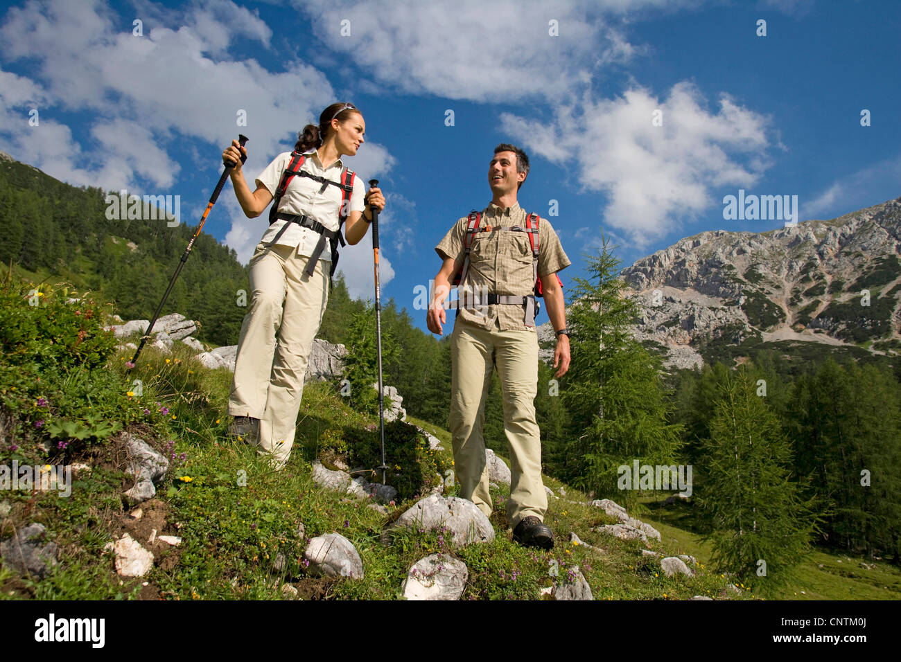 couple wandering in a mountain scenery. Man and woman walking through a ...