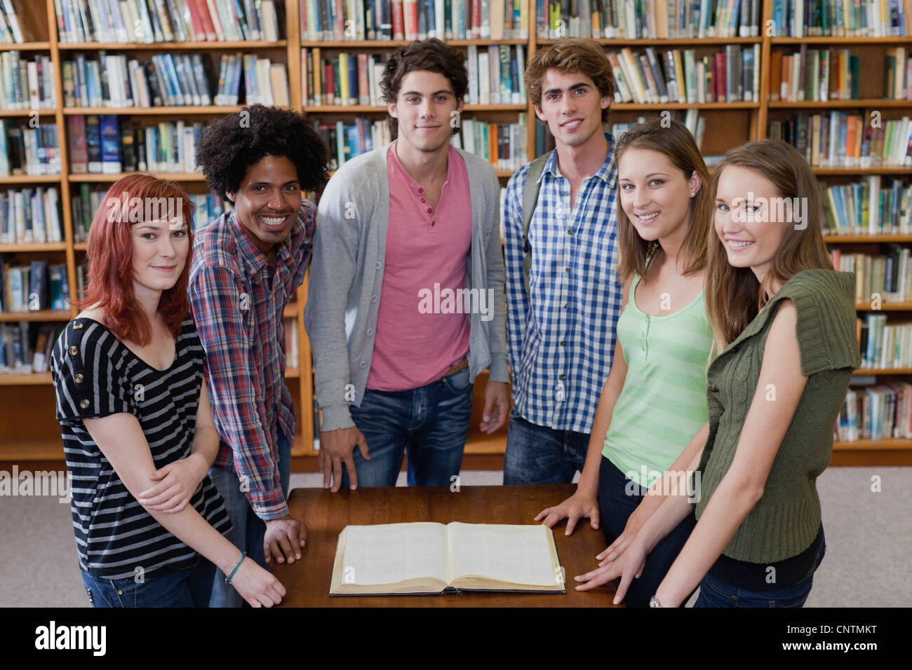 Students reading book in library Stock Photo - Alamy