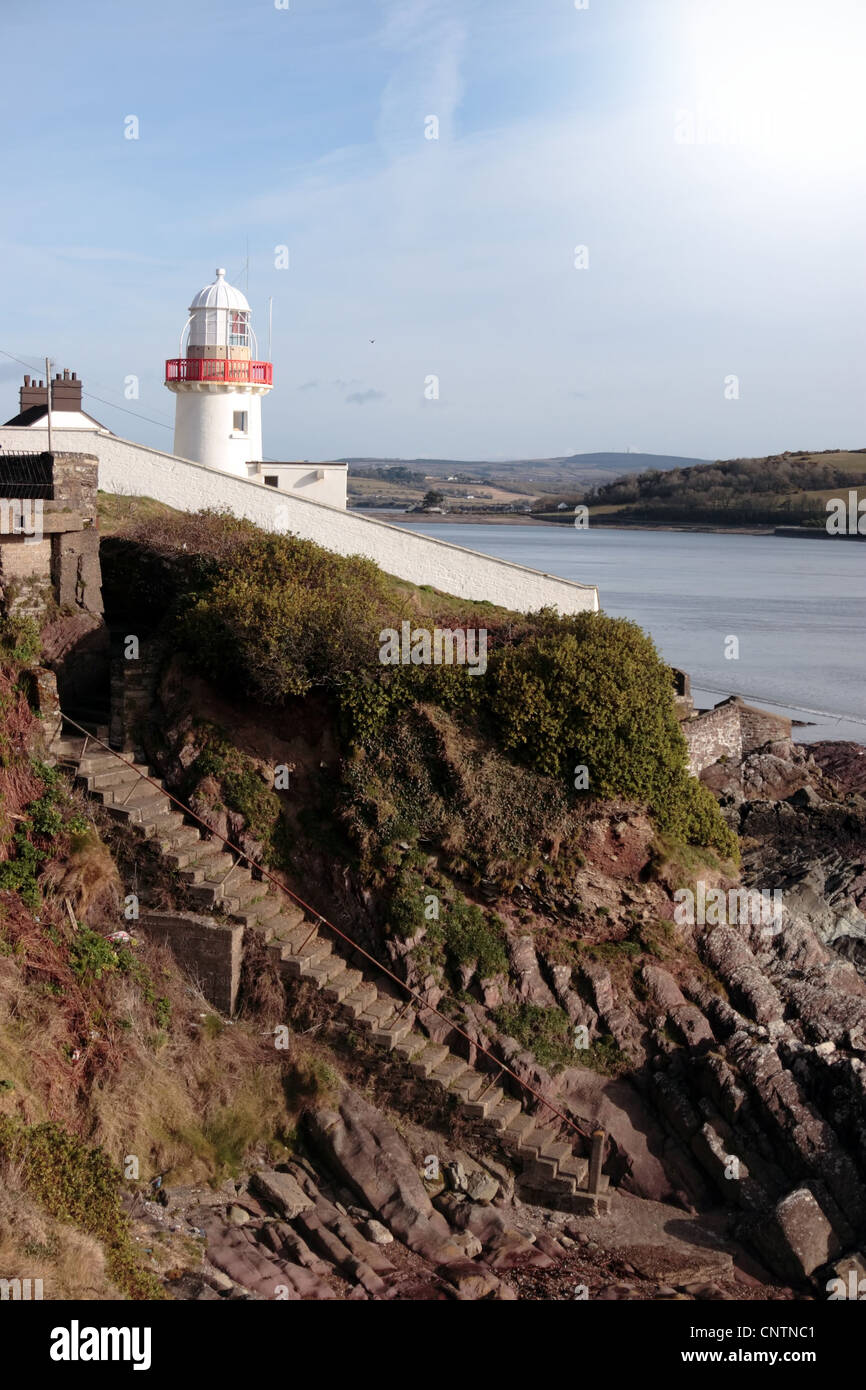 lighthouse during a sunny day on the rocks in with steps to beach in ...