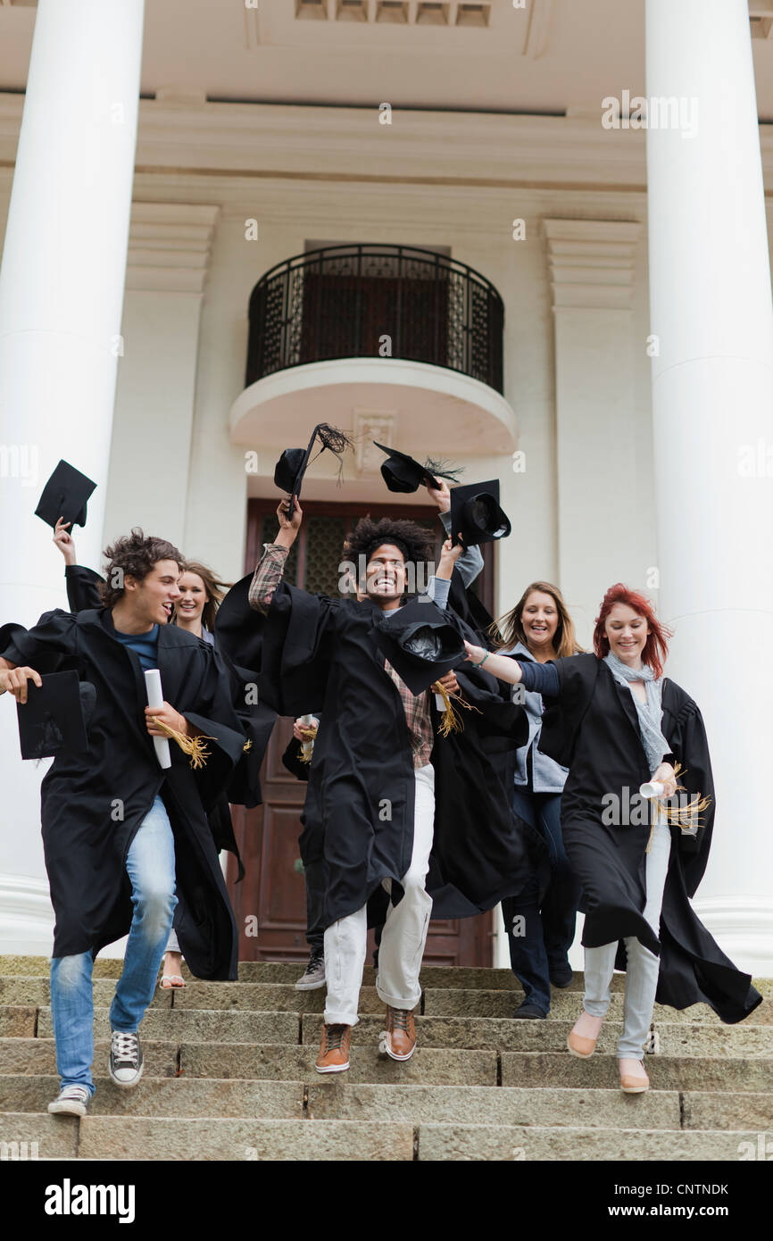 Graduates cheering on campus Stock Photo - Alamy
