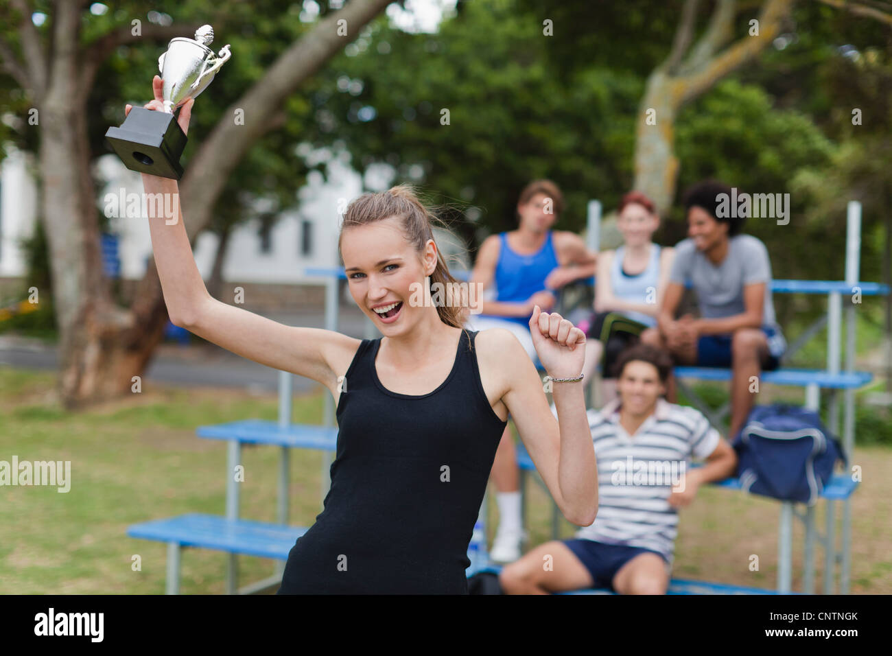 Woman holding trophy in park Stock Photo - Alamy