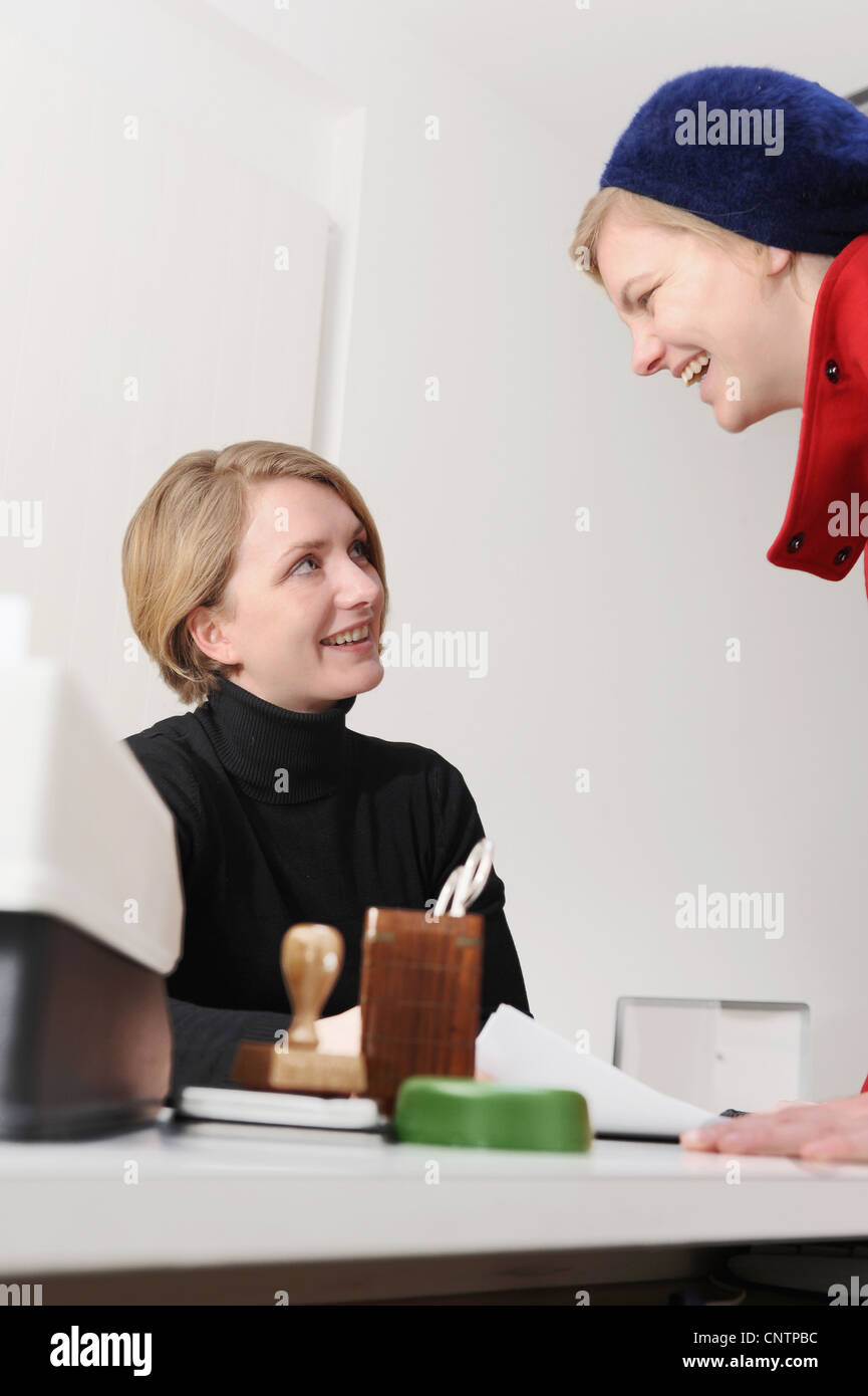 Businesswomen talking at desk in office Stock Photo - Alamy