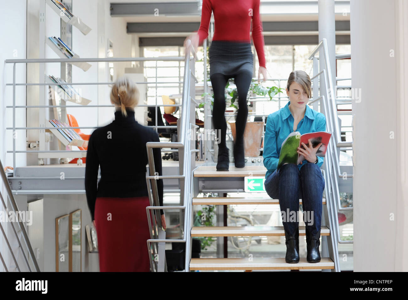 Businesswomen on steps in office Stock Photo - Alamy