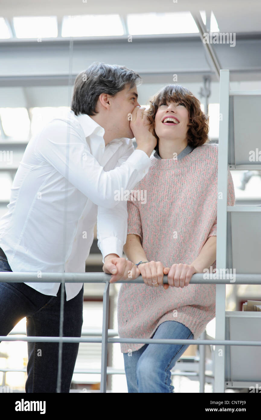 Business people whispering in office Stock Photo - Alamy