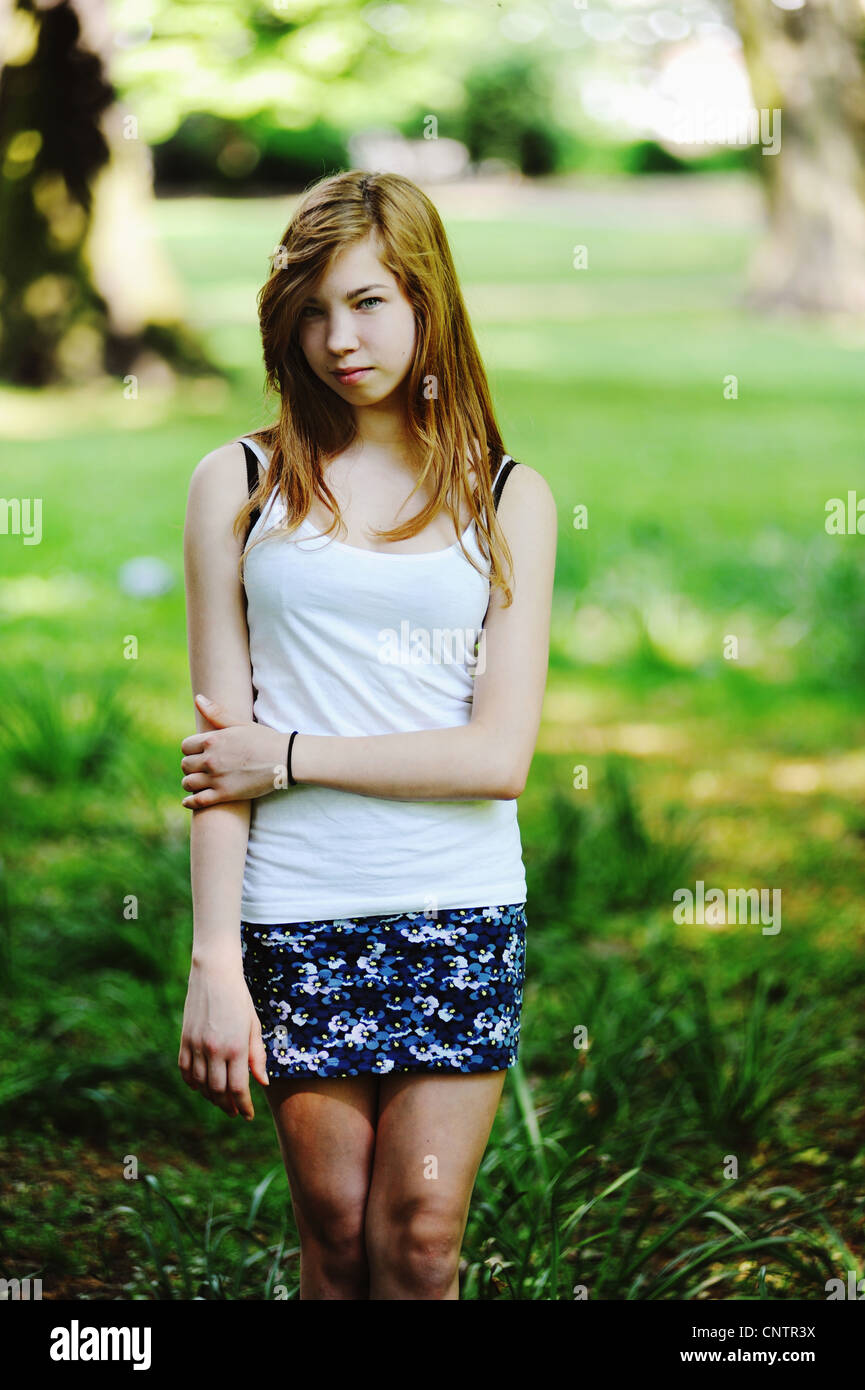 Teenage girl walking in park Stock Photo - Alamy