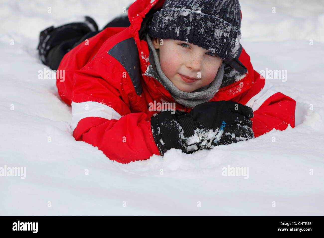 Boy lay in snow hi-res stock photography and images - Alamy