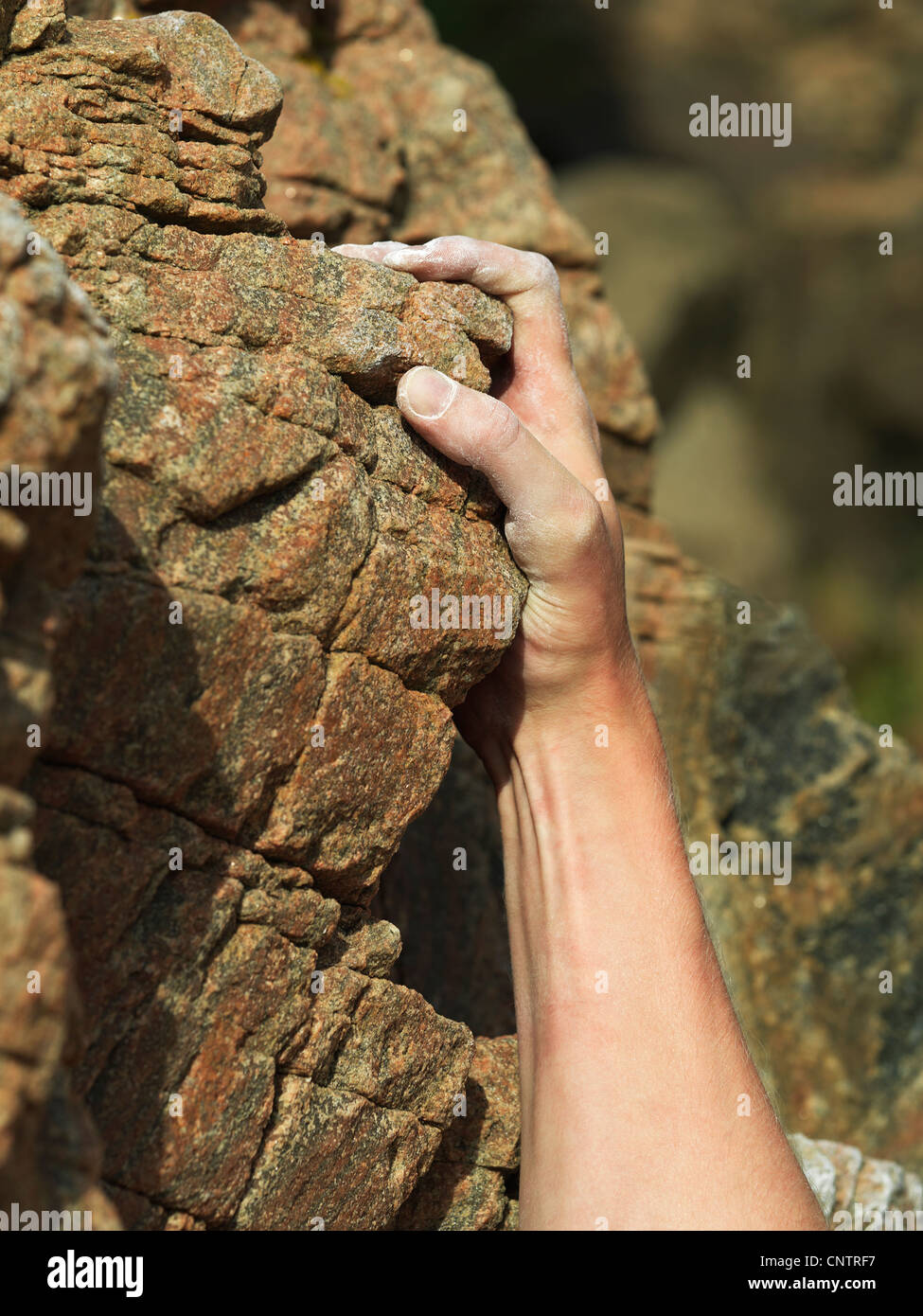 Rock climbers hand on steep rock face Stock Photo - Alamy
